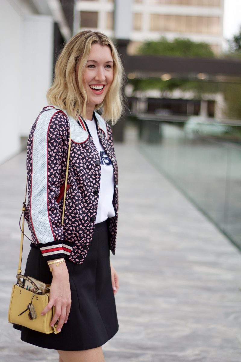 coach bomber jacket outfit. styling a bomber jacket with a skirt.